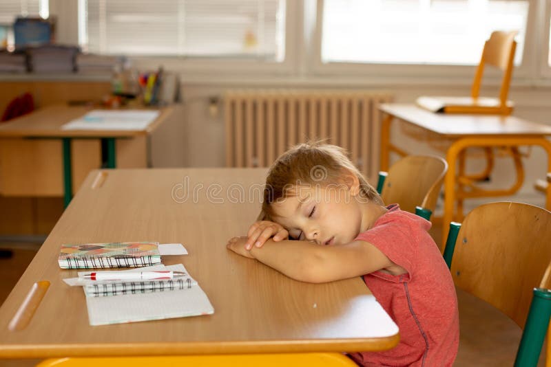 Tired Preschool Child, Sitting on a Desk at School, Having Lesson ...