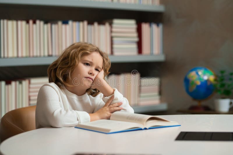 Tired School Boy, Bored Pupil at School. Pupil Reading Books in a ...