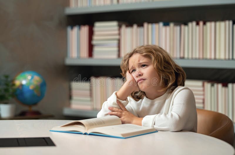Tired School Boy, Bored Pupil at School. Pupil Reading Books in a ...
