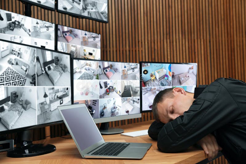 Tired Security Guard Sleeping at Workplace in Office Stock Photo ...