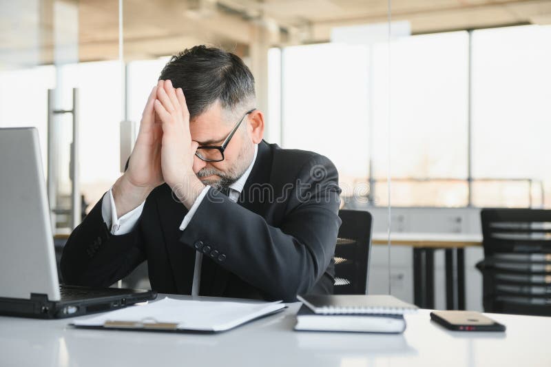 Tired Stressed Office Worker Sitting at Desk and Thinking, he is ...