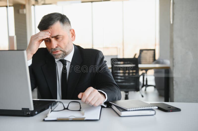 Tired Stressed Office Worker Sitting at Desk and Thinking, he is ...