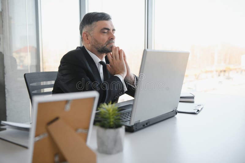 Tired Stressed Office Worker Sitting at Desk and Thinking, he is ...
