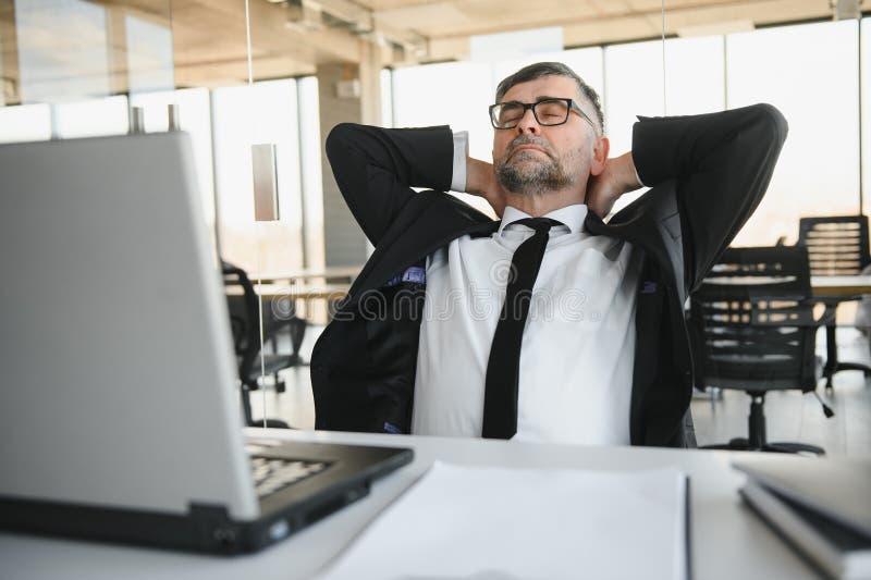 Tired Stressed Office Worker Sitting at Desk and Thinking, he is ...