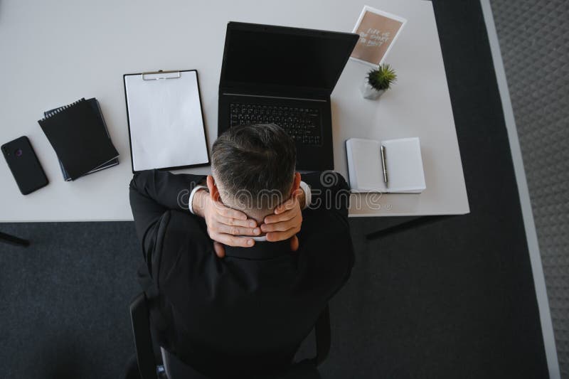 Tired Stressed Office Worker Sitting at Desk and Thinking, he is ...