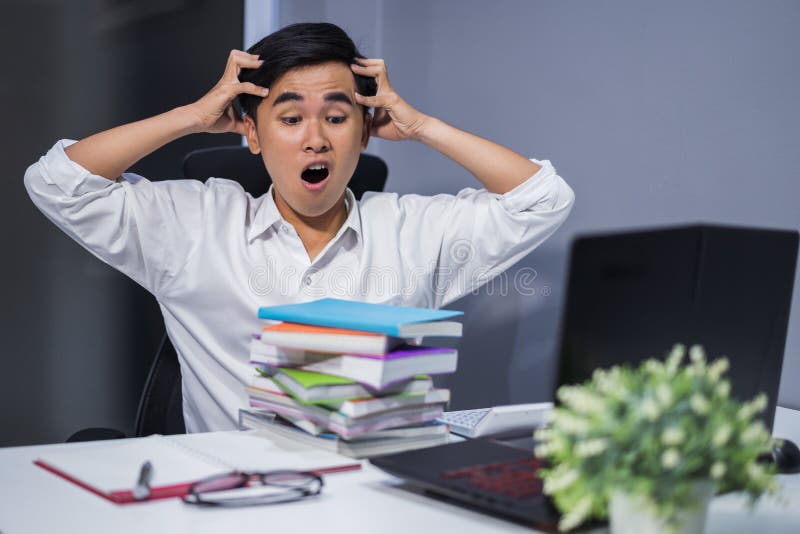 Tired Student Sitting at Table with Book and Laptop Stock Image - Image ...