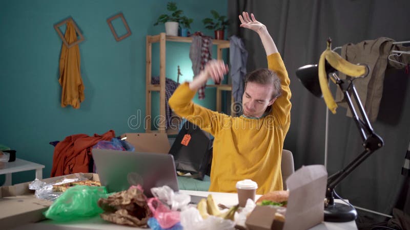 Male Student Studying in Messy Room, Making Notes Working among Garbage ...