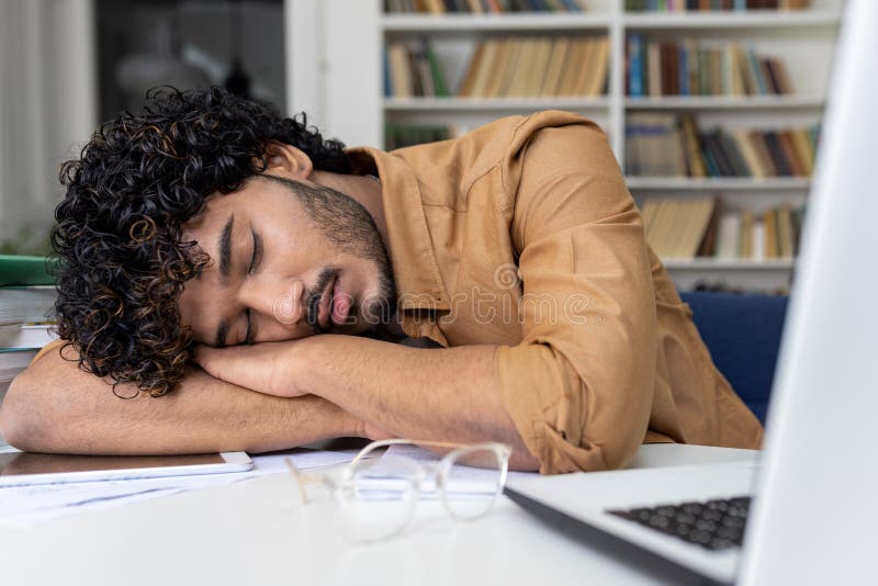 Tired Student Sleeping on Table Inside University Academic Library ...