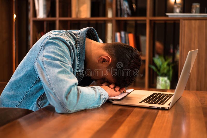 A Tired Student Sleeping on the Table while Studying or Working Inside ...