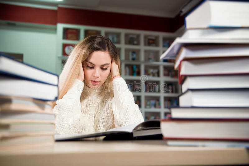 A Tired Student is Studying in the School Library. Stock Image - Image ...