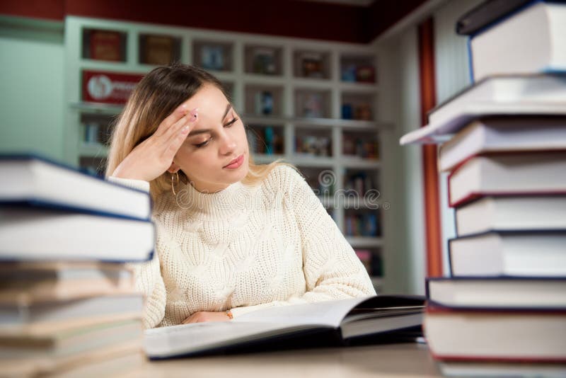 A Tired Student is Studying in the School Library. Stock Image - Image ...