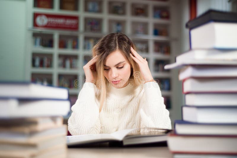 A Tired Student is Studying in the School Library. Stock Photo - Image ...