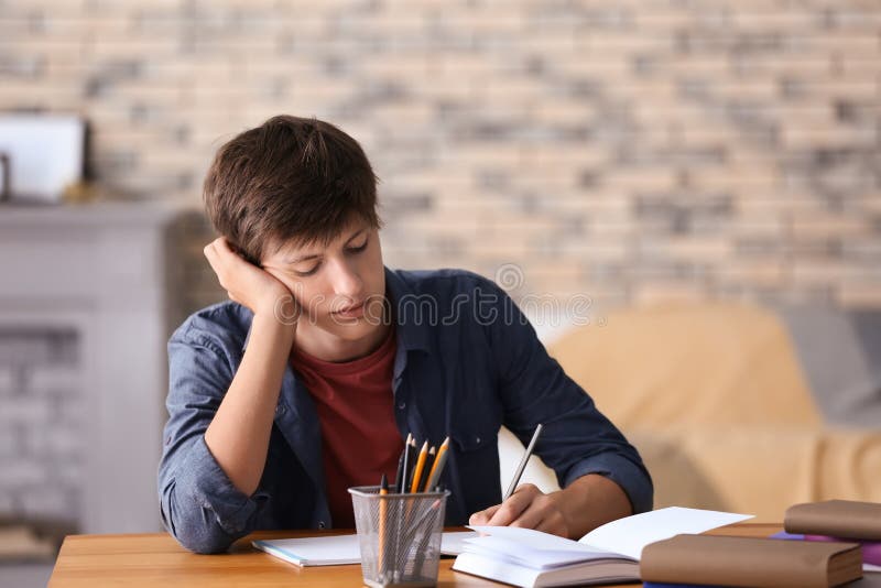 Tired Teenager Boy Doing Homework at Home Stock Image - Image of ...
