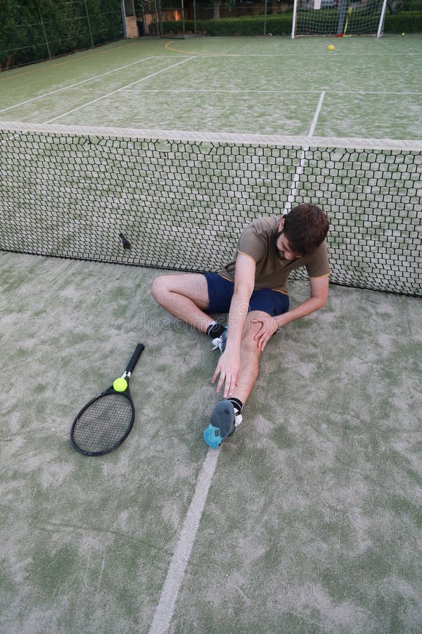 Tired Tennis Player on the Grass Court Stretching Stock Photo - Image ...
