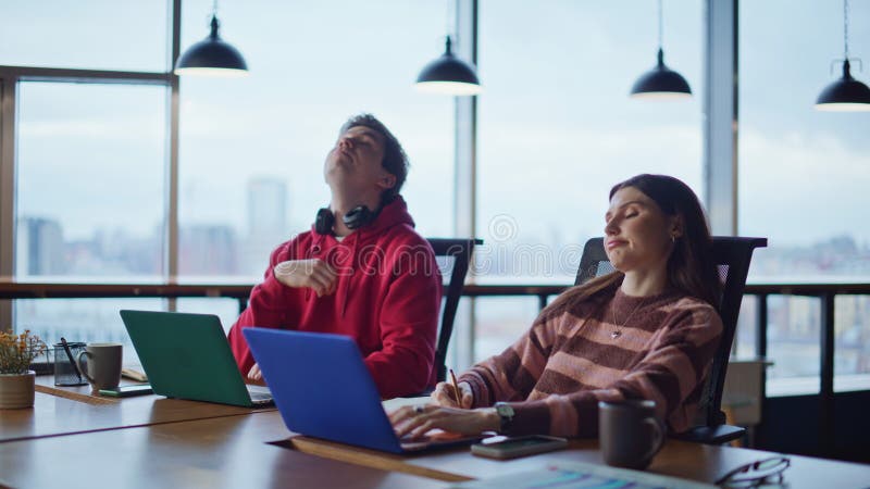 Tired Two Managers Working Laptops at Office Open Space Closeup. Sad ...