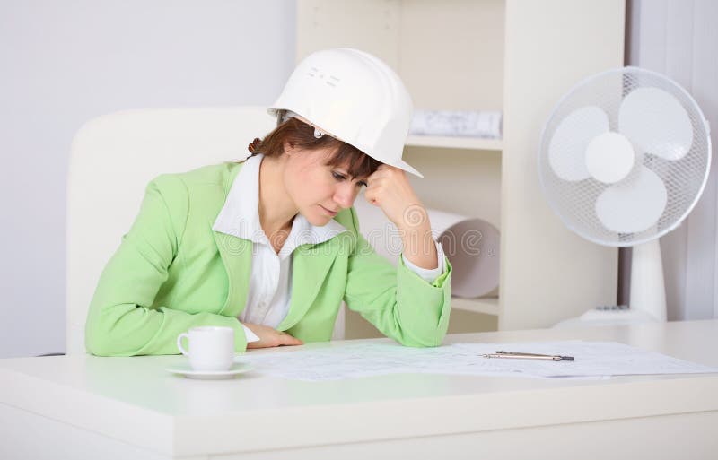 Tired Woman Engineer in Workplace Stock Photo - Image of desk, helmet ...