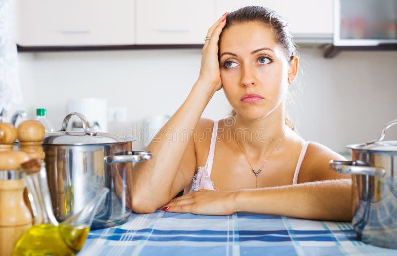 Tired woman at the kitchen stock photo. Image of grief - 72195482