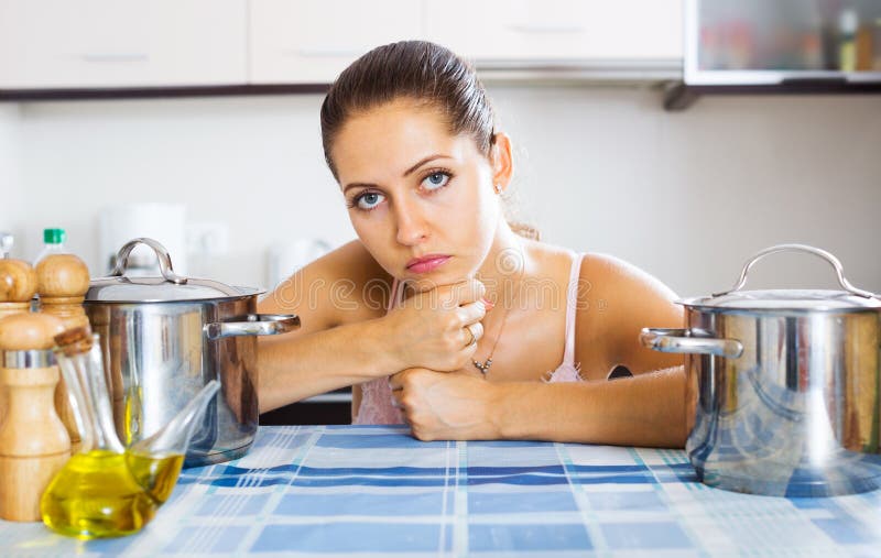 Tired woman at the kitchen stock photo. Image of posing - 57115914