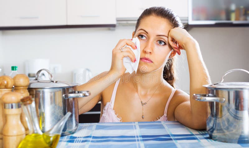 Tired woman at the kitchen stock image. Image of desperate - 63661245
