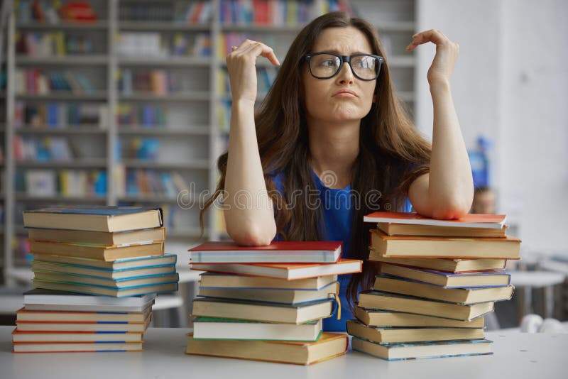 Tired Woman Sitting Front of Huge Stack of Book in Library Stock Image ...