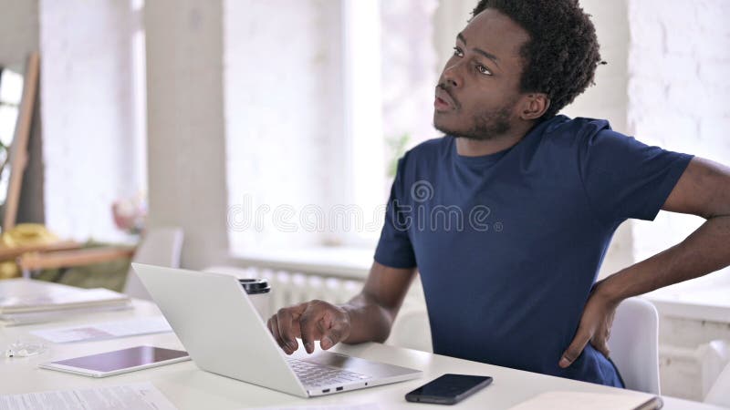 Tired Young African Man Having Back Pain in Office Stock Image - Image ...