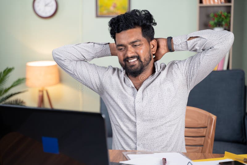 Tired Young Man Feeling Relief after Completion Work by Holding Hands ...