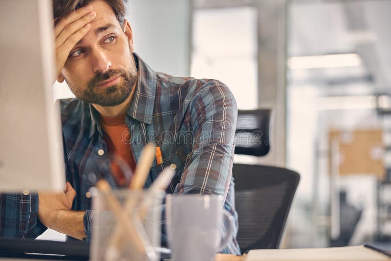 Tired Young Man Sitting at the Table in Office Stock Image - Image of ...