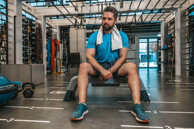 Tired Young Sitting and Resting after the Workout Stock Photo - Image ...