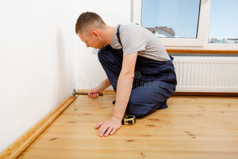 To Make Repairs. Installing a New Skirting Board Stock Image - Image of ...