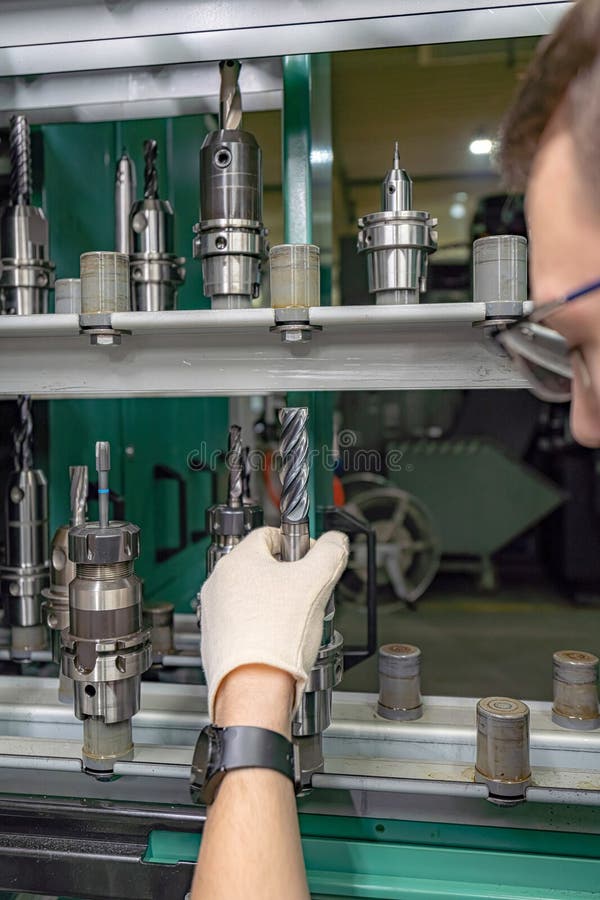 To Operate a CNC Machine, a Worker Selects and Inspects the Required ...