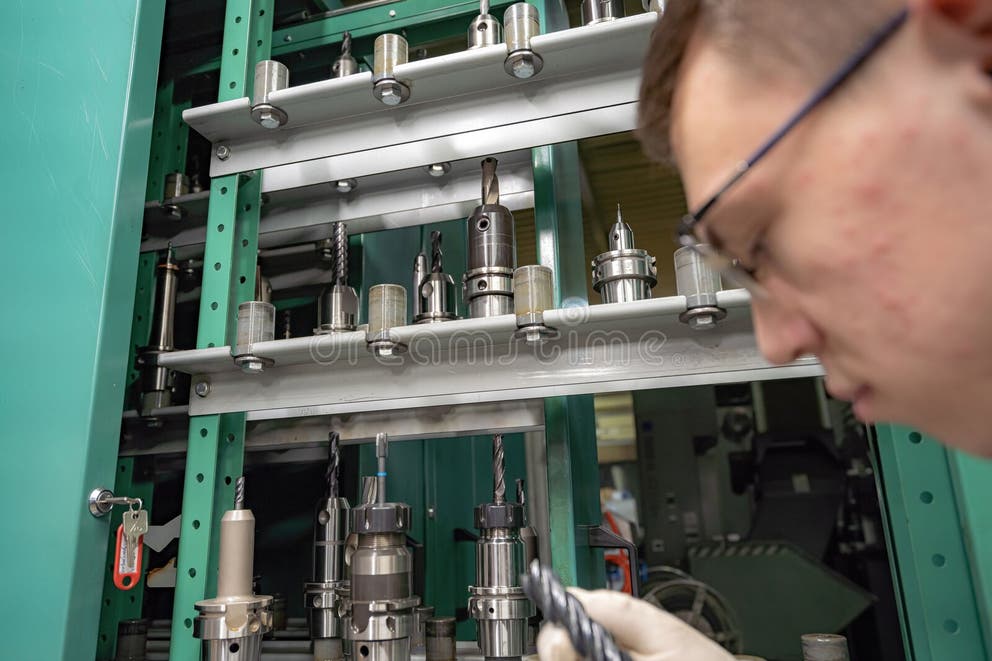 To Operate a CNC Machine, a Worker Selects and Inspects the Required ...