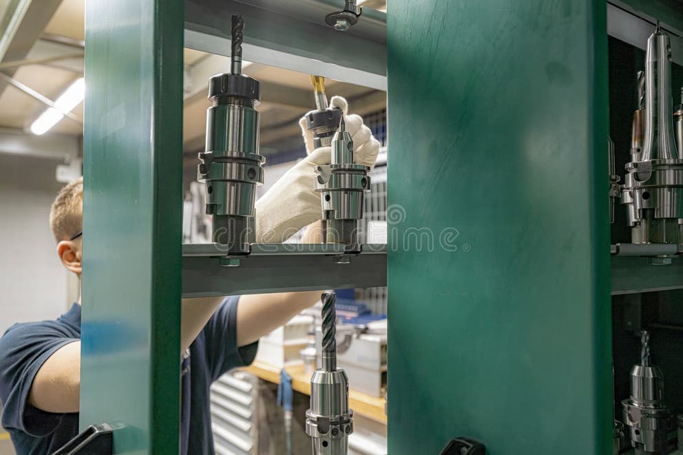 To Operate a CNC Machine, a Worker Selects and Inspects the Required ...