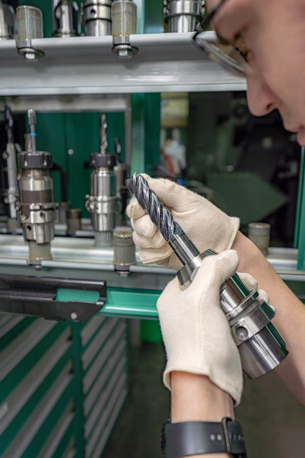 To Operate a CNC Machine, a Worker Selects and Inspects the Required ...