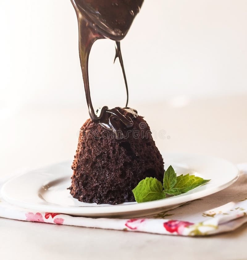 To Pour Chocolate Cake with Chocolate Syrup and Mint Leaves on a Stock ...