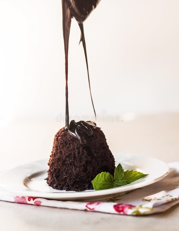 To Pour Chocolate Cake with Chocolate Syrup and Mint Leaves on a Stock ...
