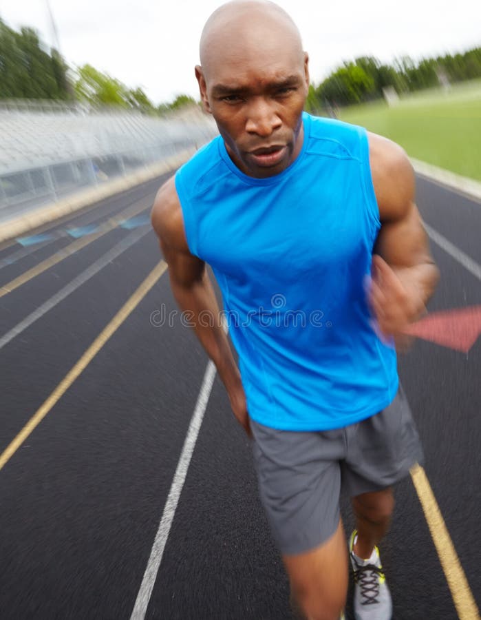 In it To Win. Cropped Front View of a Focused Male Athlete Running on ...
