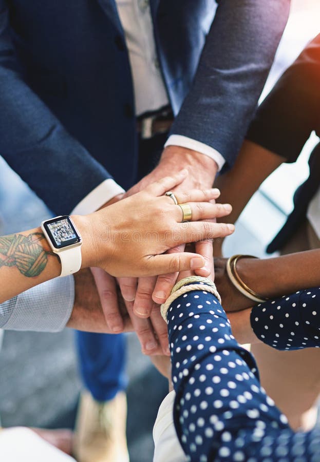 In it To Win it. High Angle Shot of a Group of Coworkers Hands in a ...