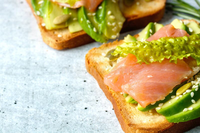 Toast with Avocado and Salmon Fish on the Table Stock Photo - Image of ...