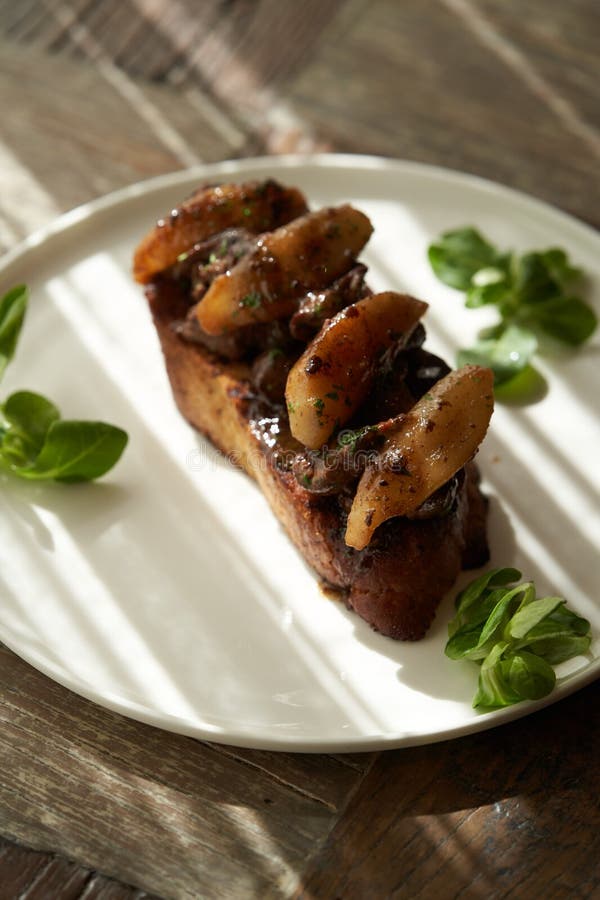 Toast with Baked Chicken Liver on White Plate on Table Stock Photo ...