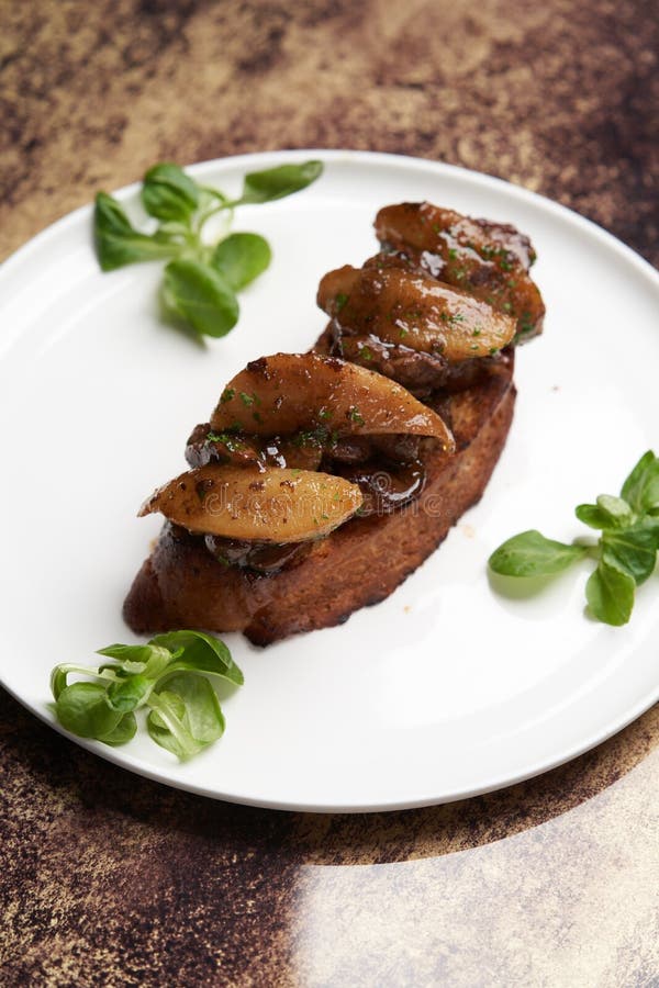 Toast with Baked Chicken Liver on White Plate on Table Stock Image ...