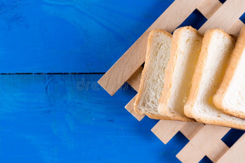 Toast Bread Slices on the Blue Wooden Planks Board Stock Image - Image ...