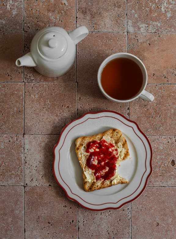 Toast with Butter and Raspberry Jam and Tea on a Stone Background, Top ...