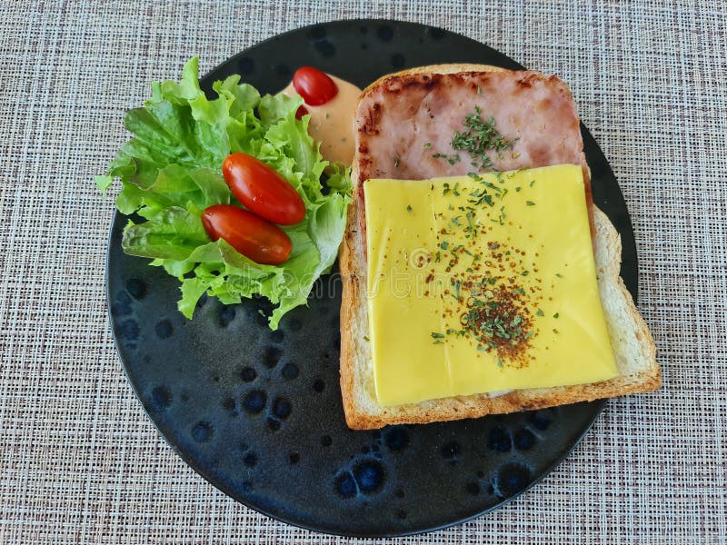 Toast with Ham Cheese with Fresh Vegeatable on the Black Plate ...