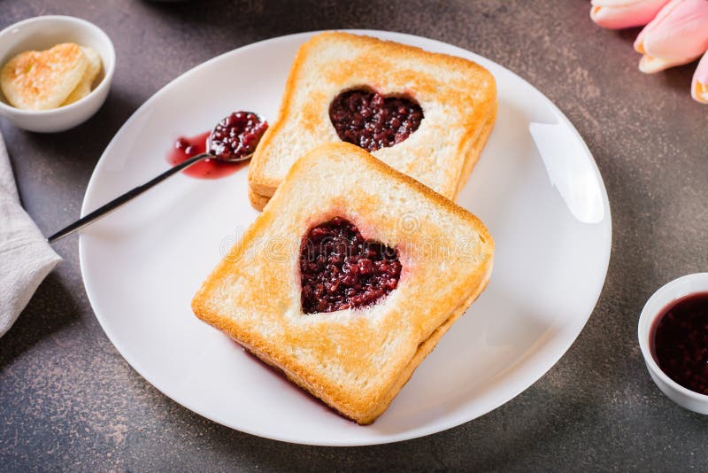 Toast with a Heart Filled with Raspberry Jam on a Plate. Breakfast for ...