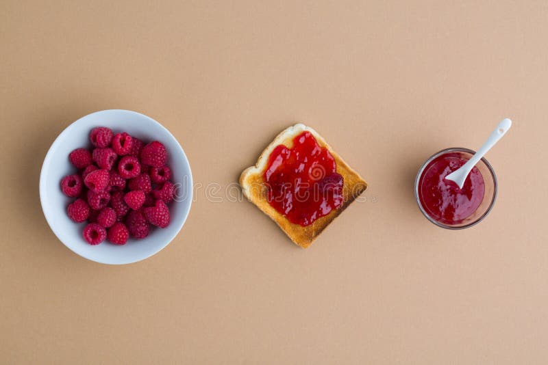 Toast with Jam and Raspberry on Beige Table. Top View Stock Photo ...