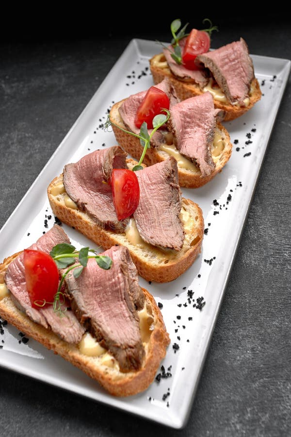 Toast with Meat and Tomatoes on a Plate. Vertical Stock Photo - Image ...