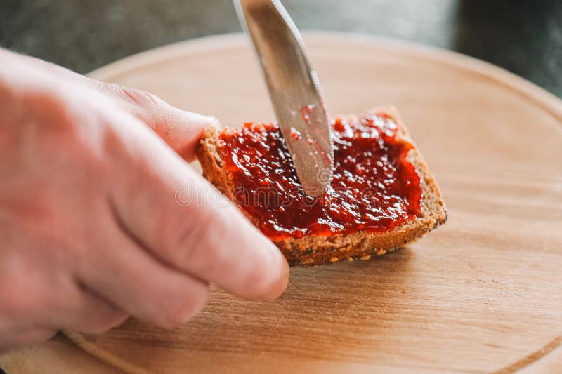Toast with Raspberry Jam.Sweet Breakfast. Hands Spread Raspberry Jam on ...
