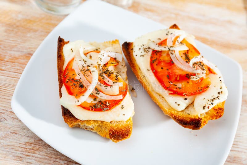 Toasted Bread with Cheese, Onion and Tomato Stock Photo - Image of ...