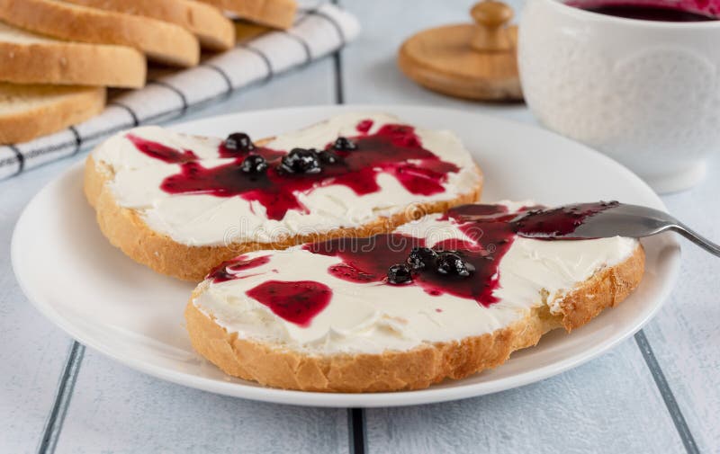 Toasted Bread with Cream Cheese and Jam on a Wooden Table Stock Image ...