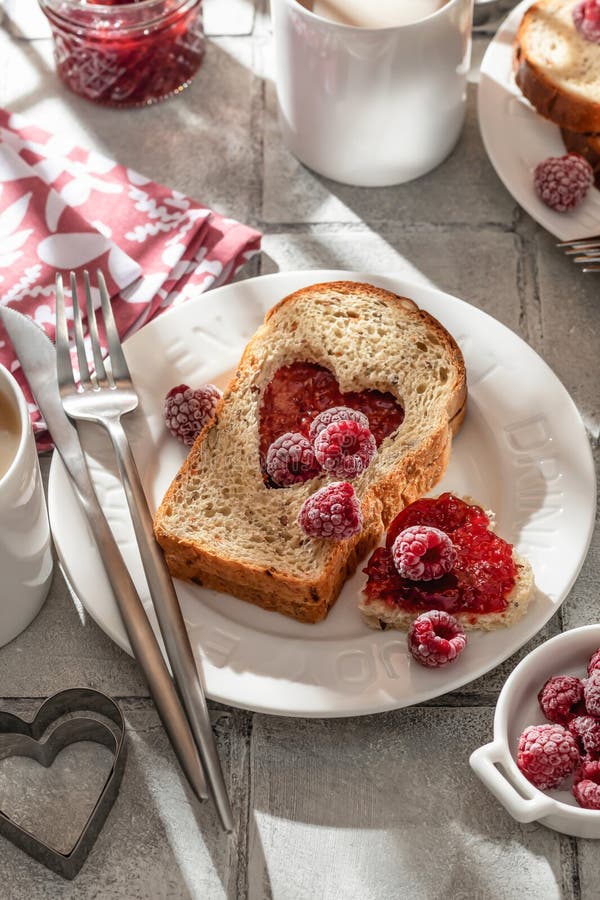 Toasted Bread with Heart-shaped Cut and Raspberry Jam on Tile ...
